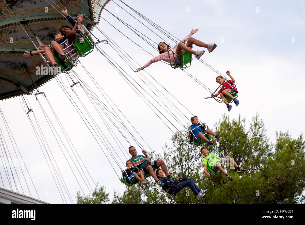 BARCELONA - SEP 5: People have fun at the carousel flying swing ride ...