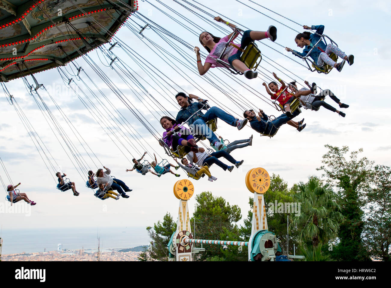 BARCELONA - SEP 5: People have fun at the carousel flying swing ride ...