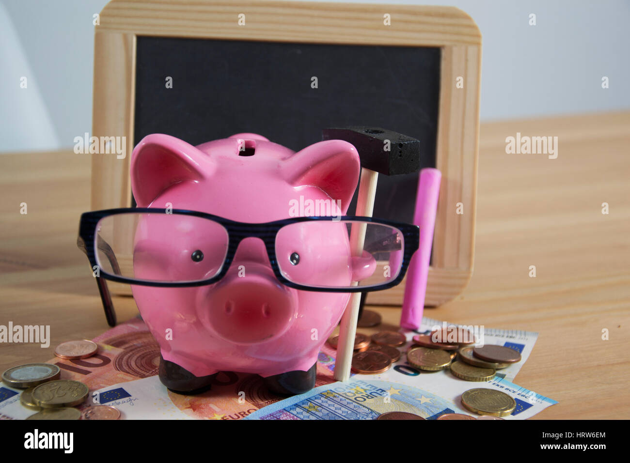 a pink piggy bank with money Stock Photo - Alamy