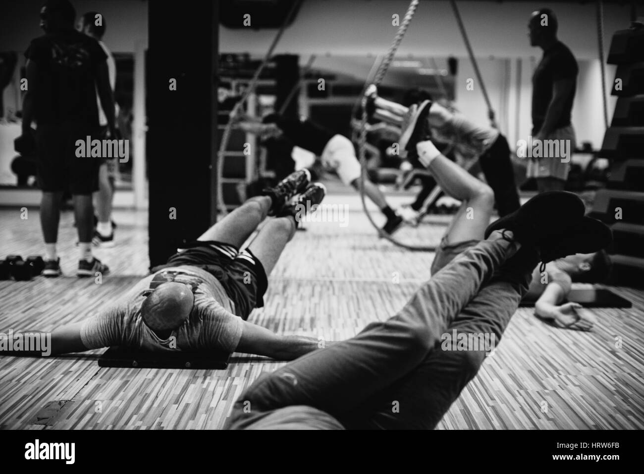 crossfit group training. Man and woman group training indoors. Black ...