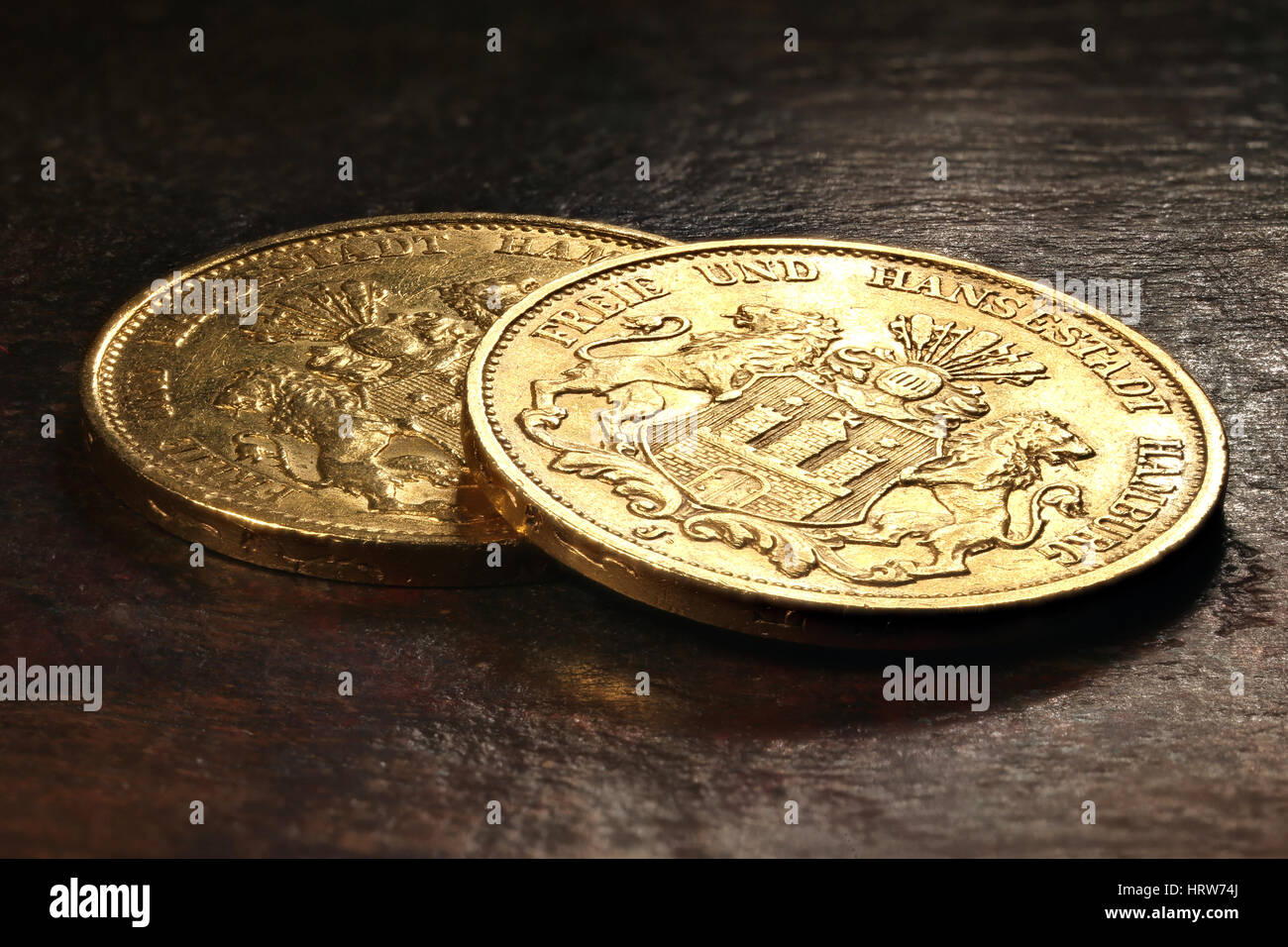 Hamburg gold coins (German Empire Goldmark) on rustic wooden background ...