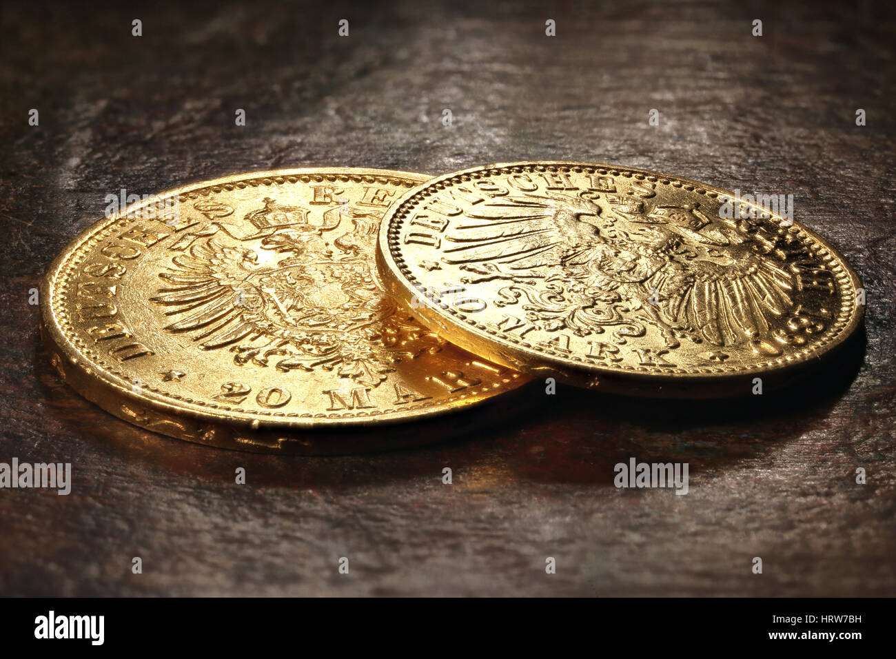 Hamburg gold coins (German Empire Goldmark) on rustic wooden background ...