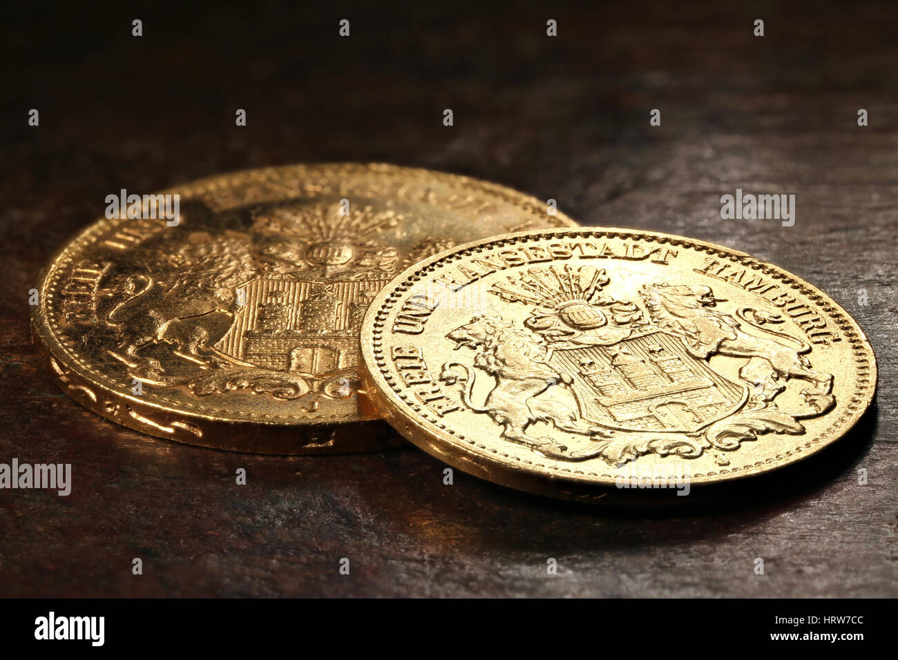Hamburg gold coins (German Empire Goldmark) on rustic wooden background ...