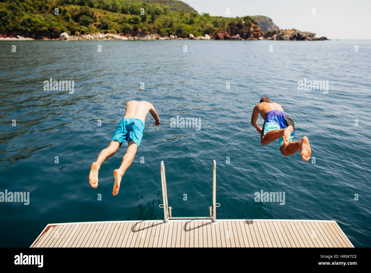 Man jumping from boat sea hi-res stock photography and images - Alamy