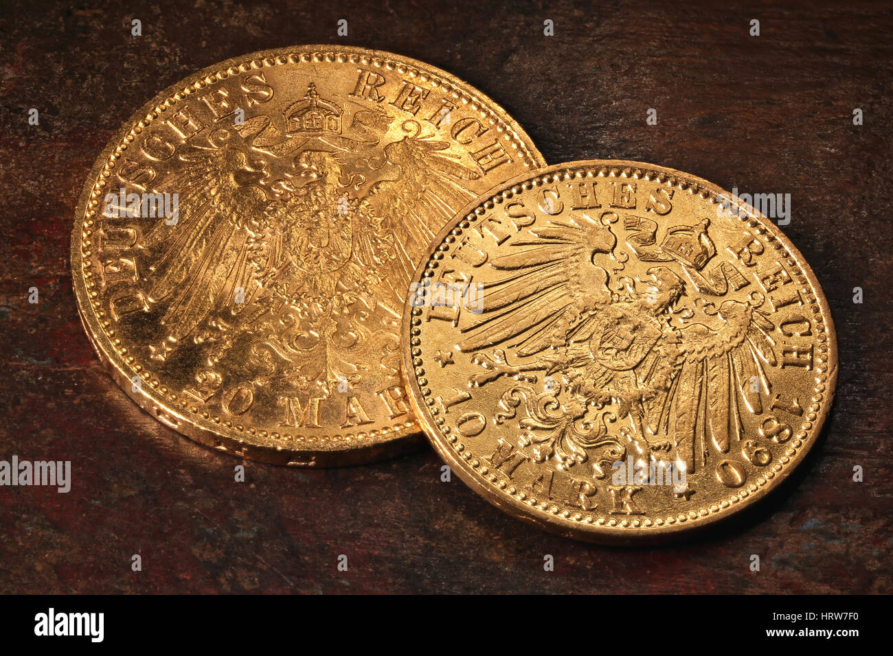 Hamburg gold coins (German Empire Goldmark) on rustic wooden background ...