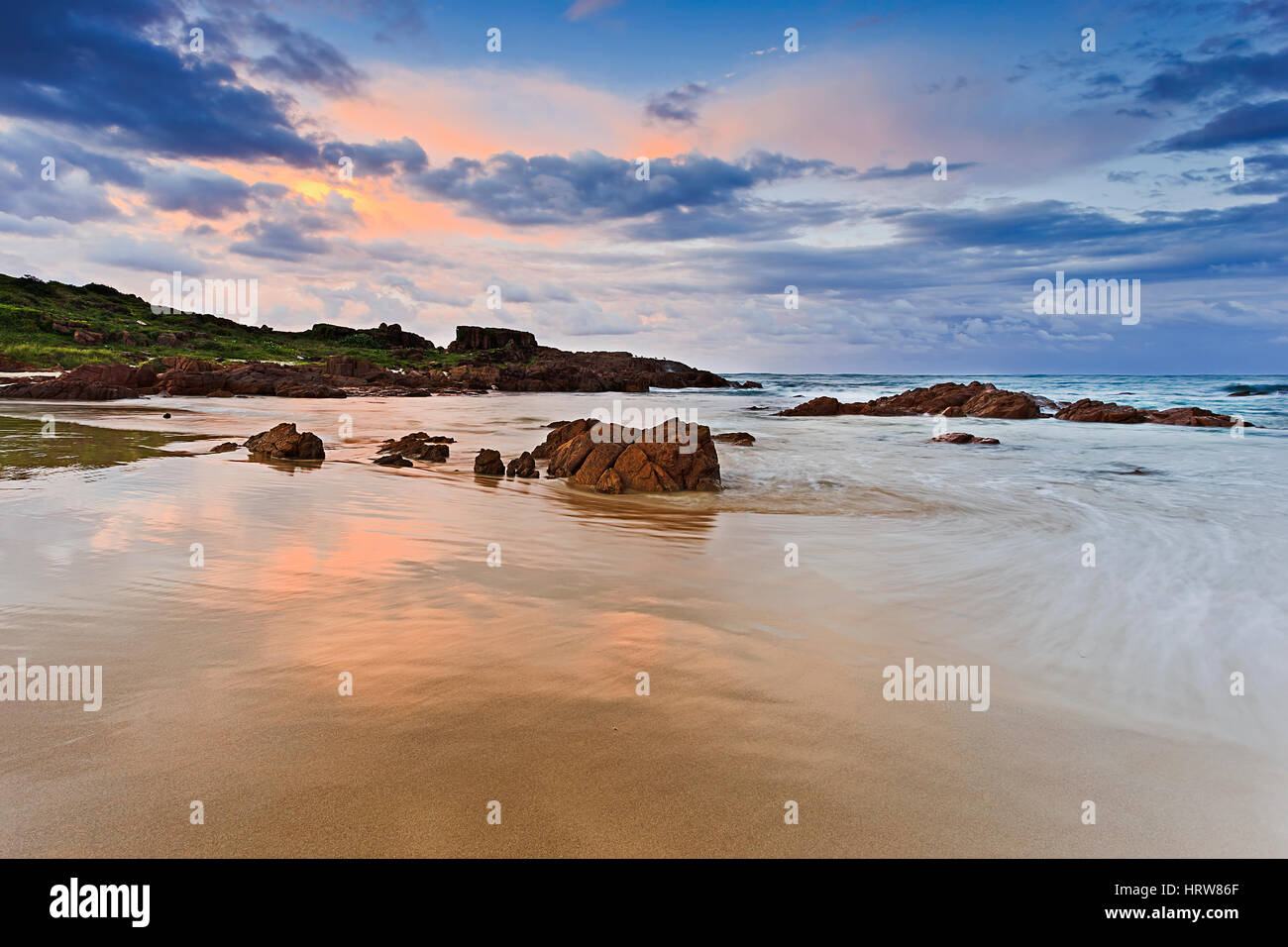 Colourful sunrise full of bright sun light at Birubi beach. Light and ...