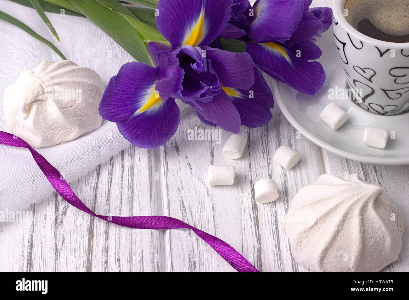 Still life with cup of coffe marshmallow zephyr iris flowers purple ...