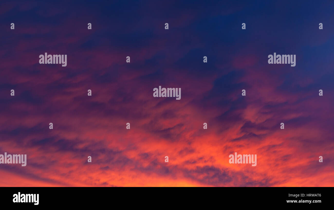 Fiery vivid sunset sky clouds scape background Stock Photo - Alamy