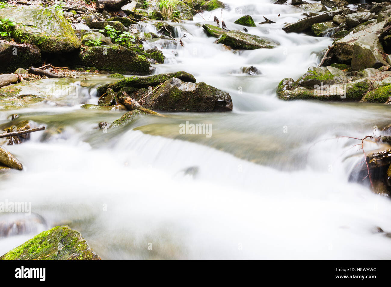 fast small mountain river flowing among stones Stock Photo - Alamy