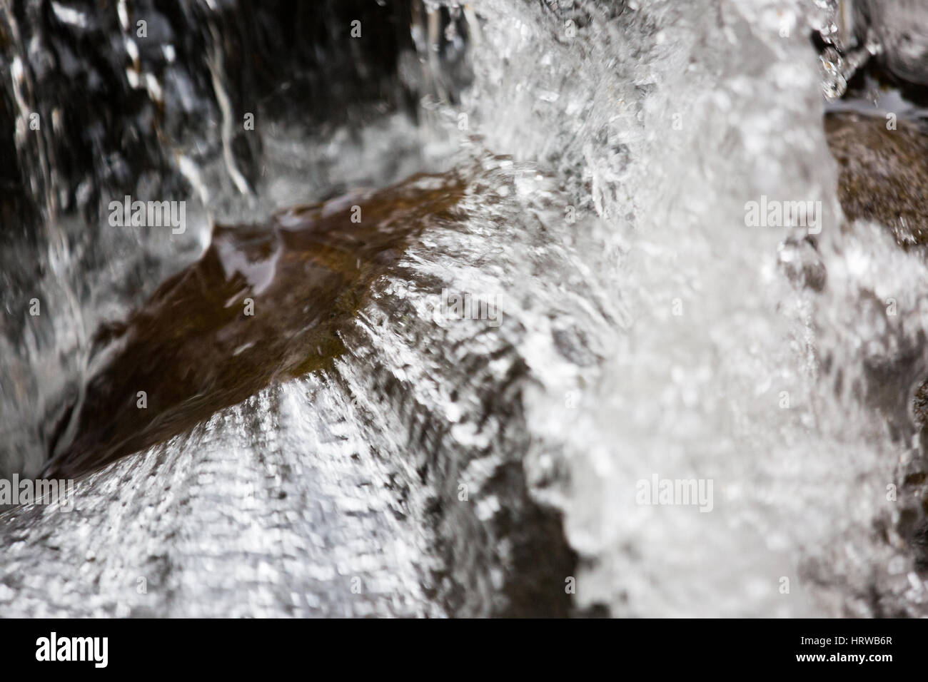 Beautiful splashes of water in a small waterfall Stock Photo - Alamy