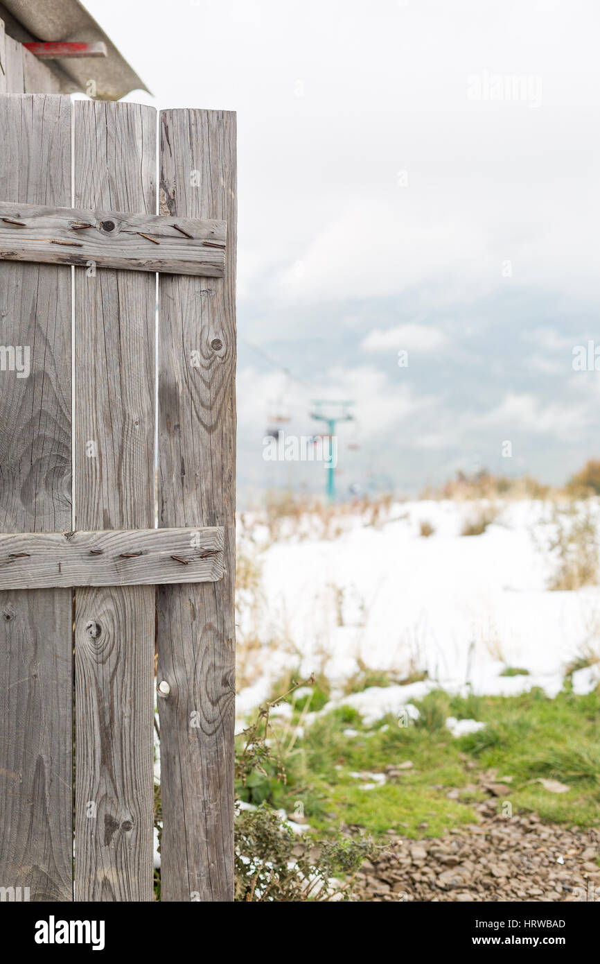 Open wooden door of the old barn on the background of the chair lift at ...
