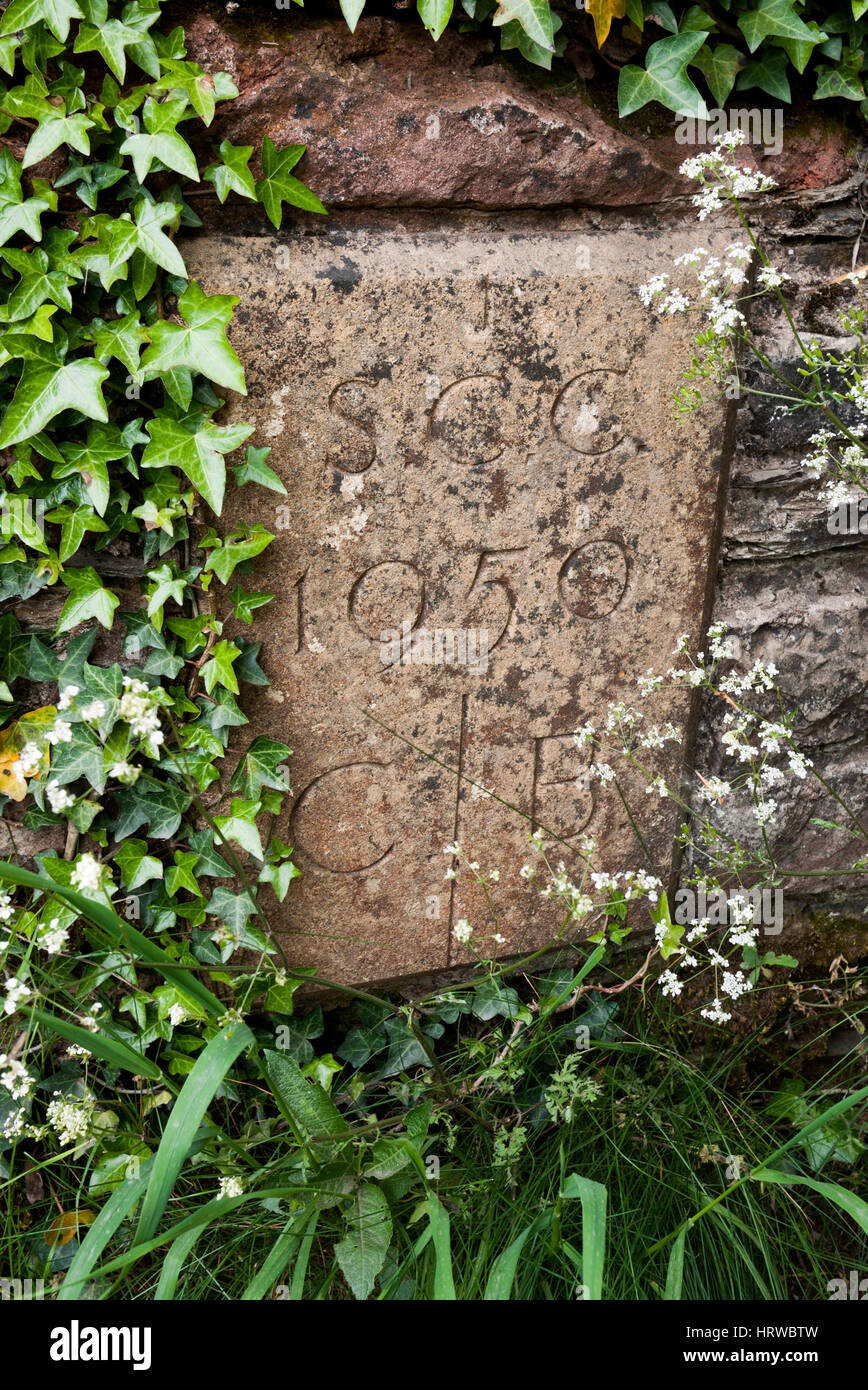A stone inset in to a wall inscribed with the year 1950 and the ...