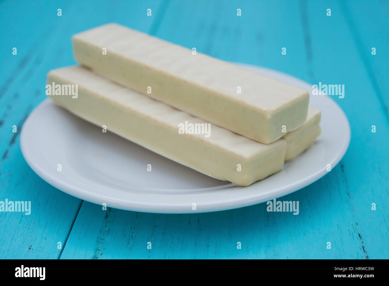 white chocolate wafer with dish on a blue ackground Stock Photo - Alamy