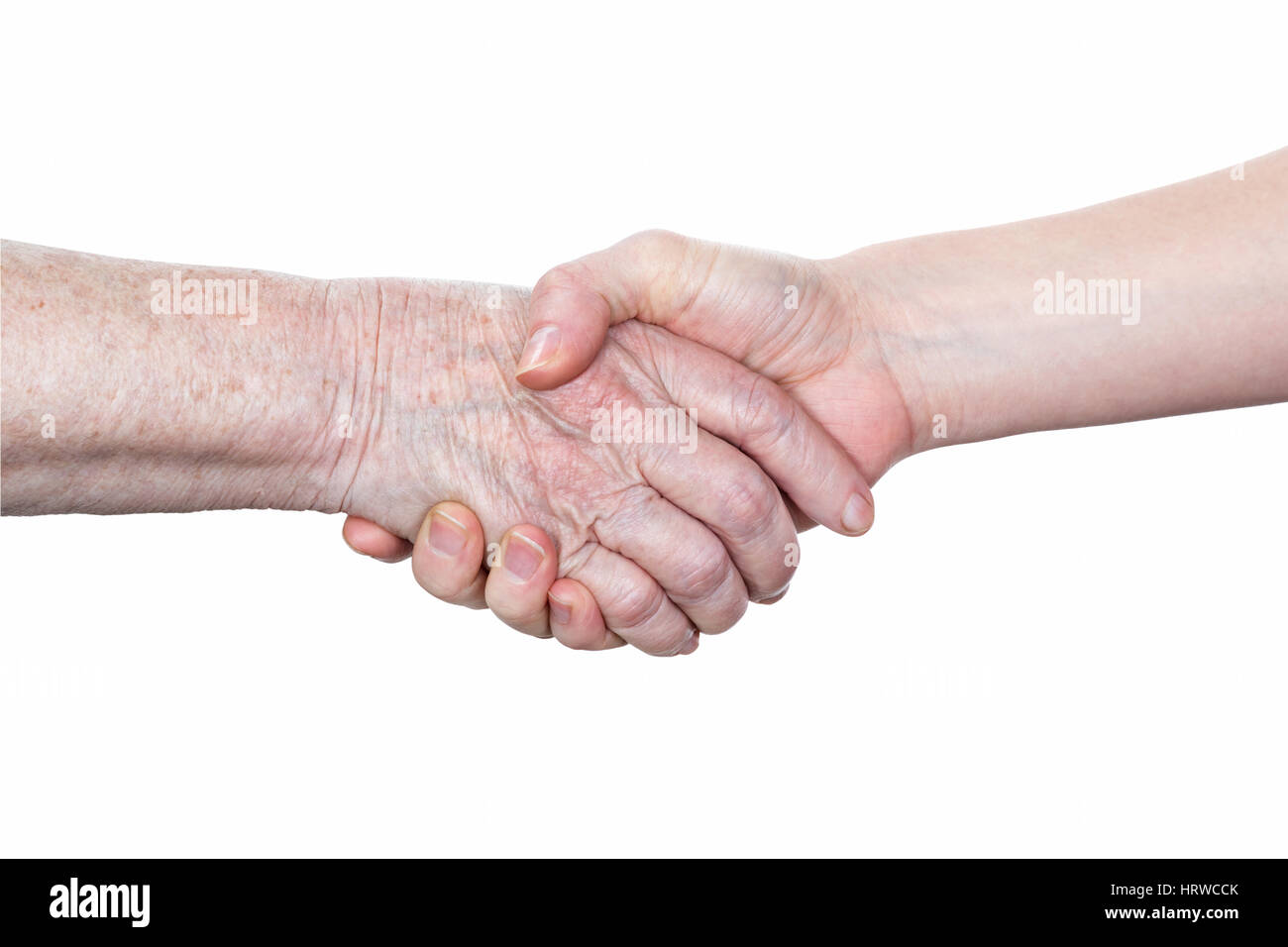 Handshake between an old woman with a wrinkled hand and a young woman ...