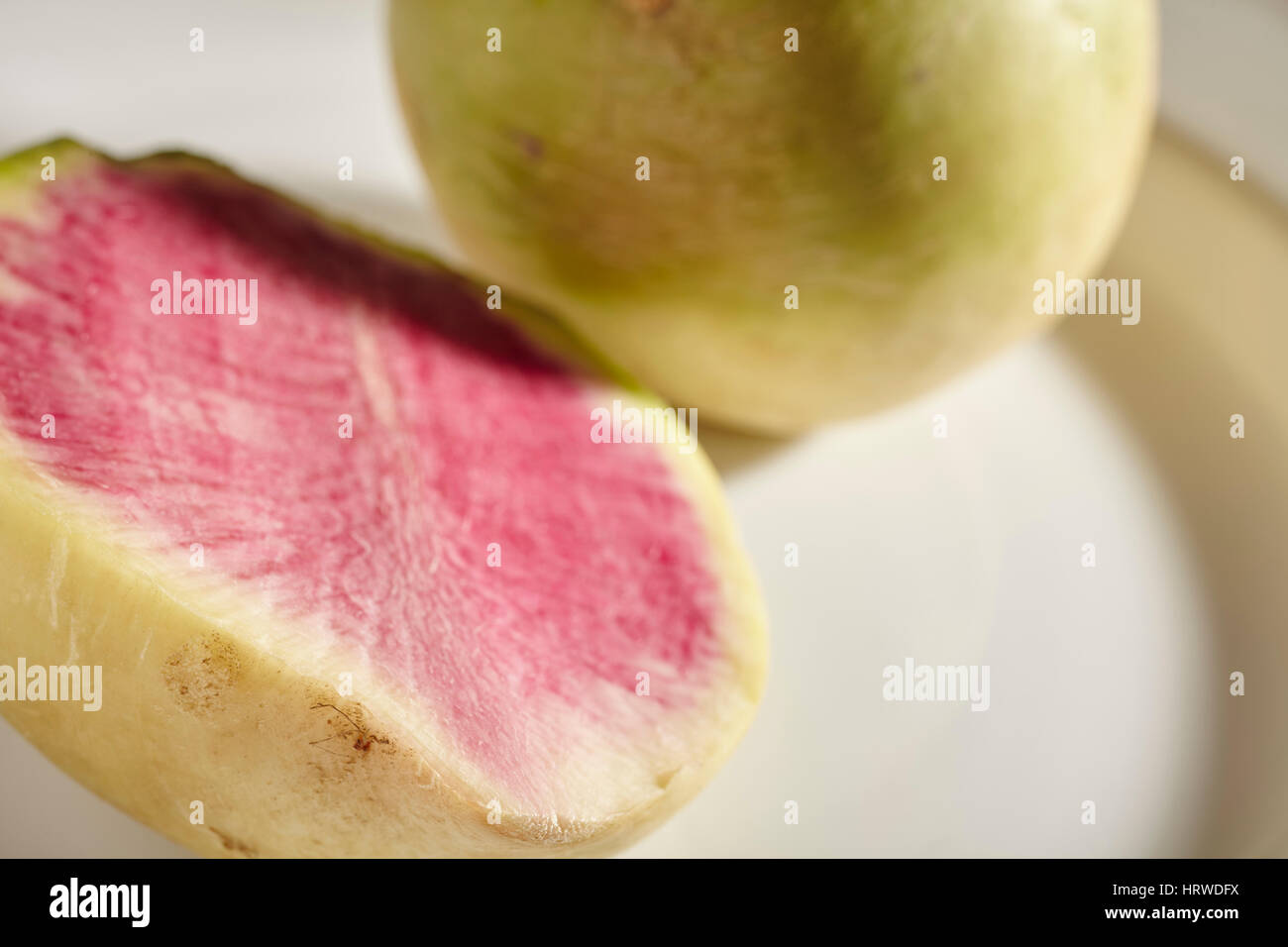 Watermelon Radishes. One is cut open to show how the inside is red ...