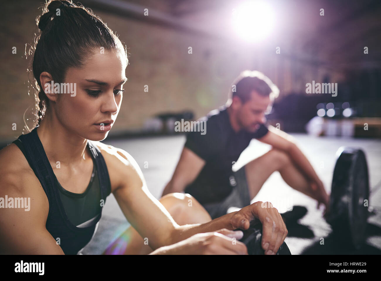 Sportive people sitting and recreating in gym. Horizontal indoors shot ...