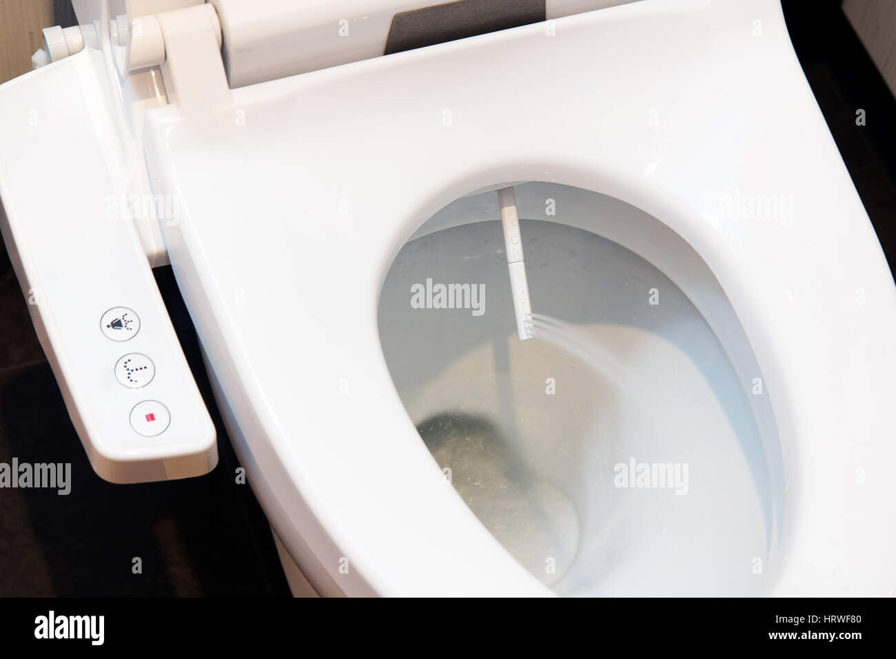 toilet bowl with electronic control bidet Stock Photo - Alamy