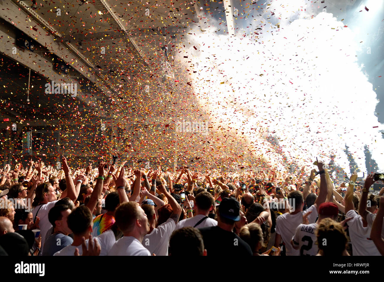 BARCELONA - JUN 19: Crowd in a concert, while throwing confetti from ...