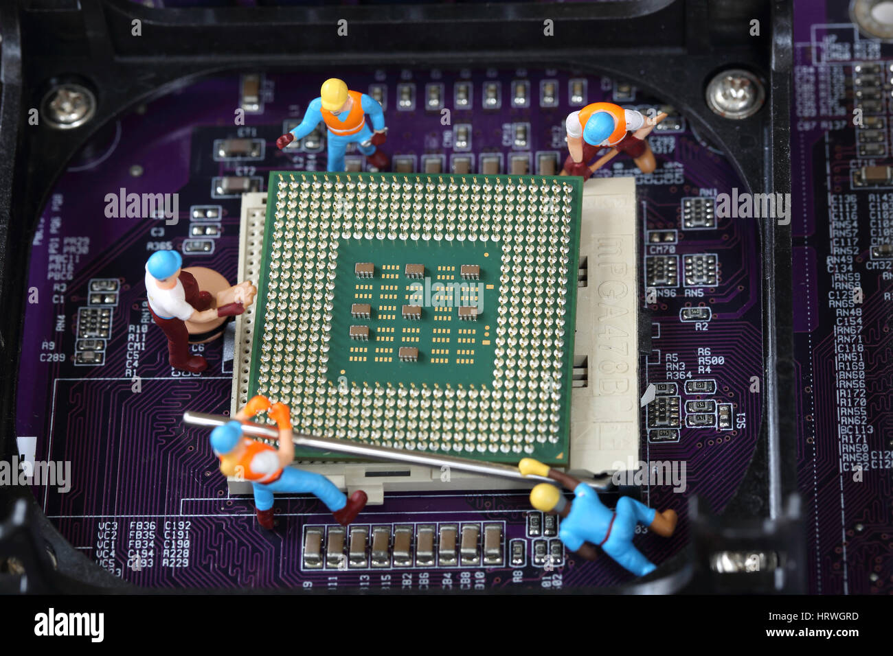 Selective focus of miniature engineer and worker repair CPU processor ...