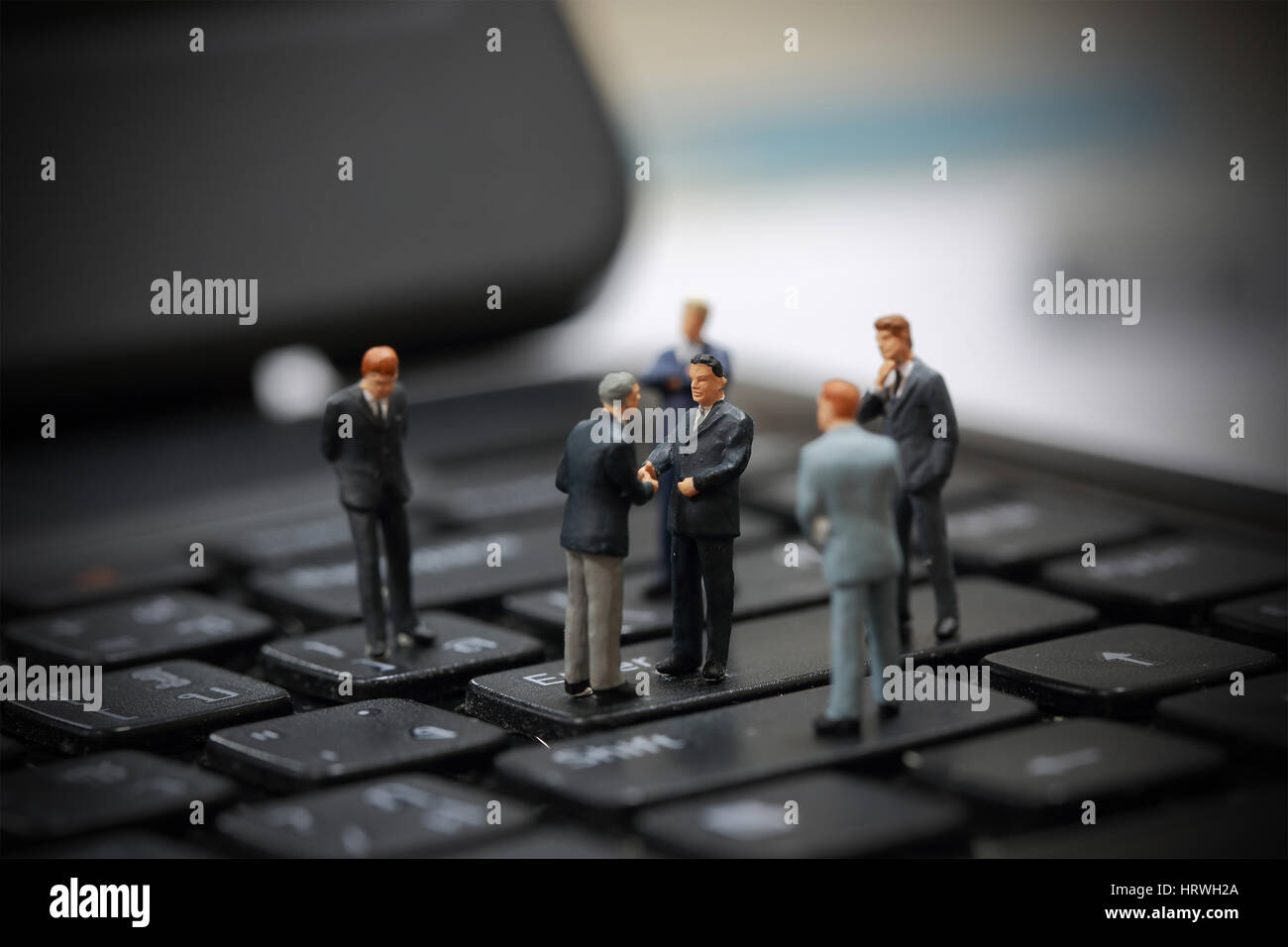 Selective focus of miniature businessman handshake about business ...