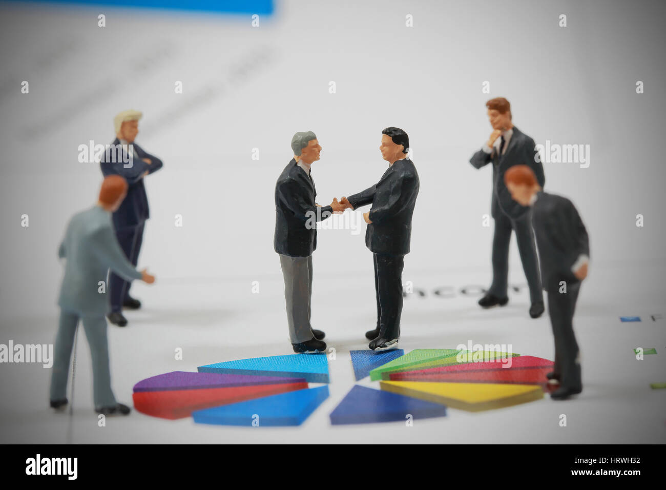 Top view selective focus of miniature business man handshake on ...