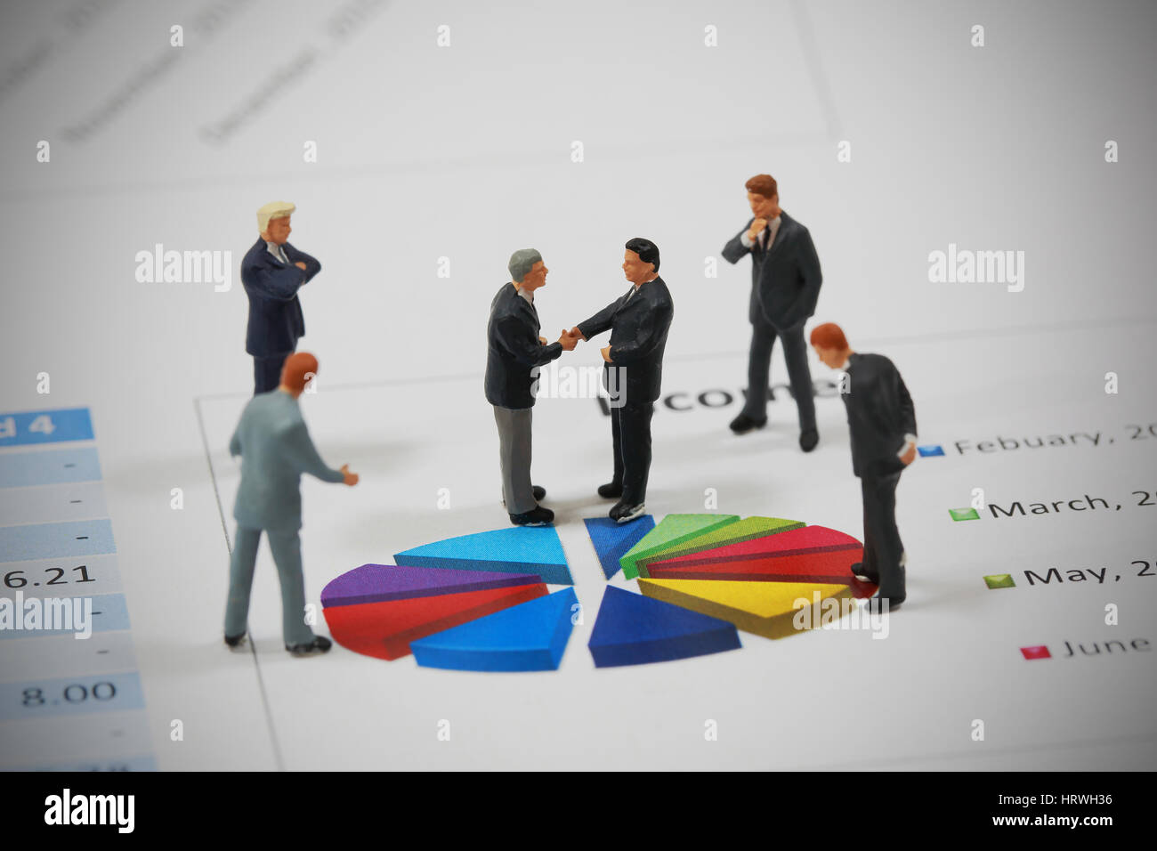 Top view selective focus of miniature businessman handshake on colorful ...