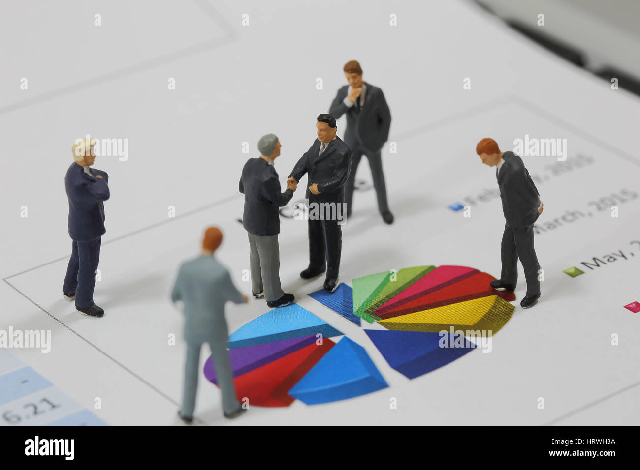 Top view selective focus of miniature business man handshake on ...