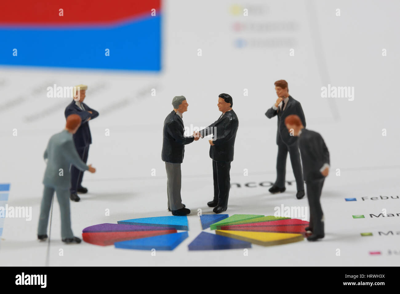 Selective focus of miniature businessman handshake on circle chart ...