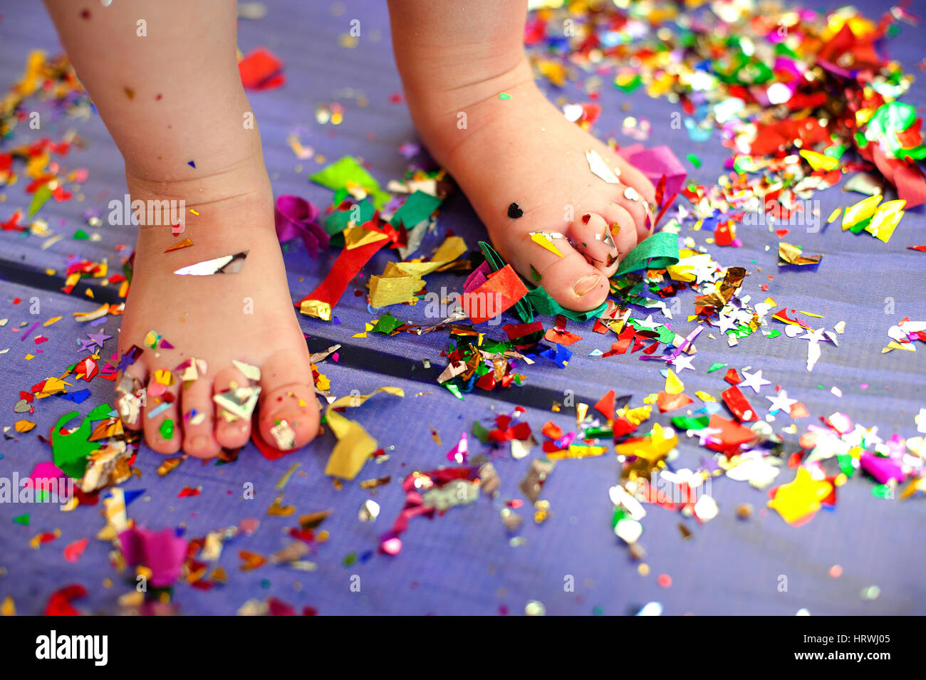 children's birthday party. bare feet are on the floor with confetti ...