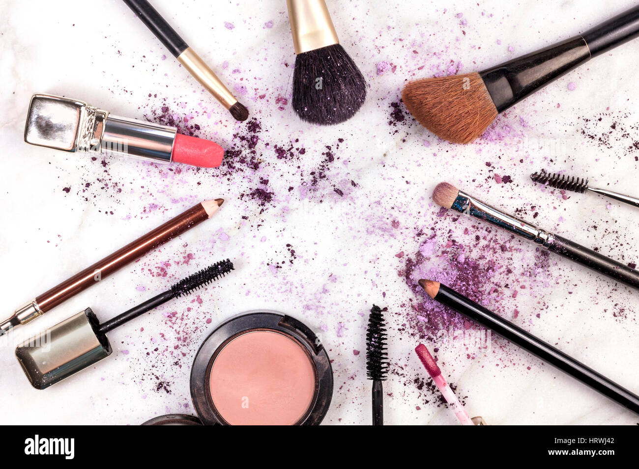 Makeup brushes, pencil, lipstick and other objects, forming a frame on ...