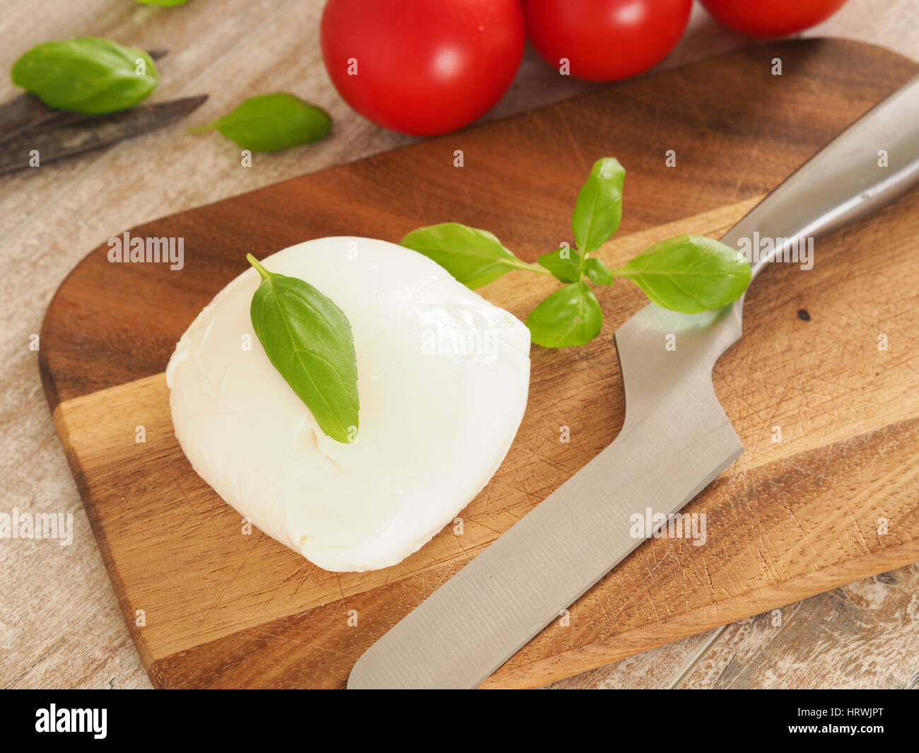 Fresh organic mozzarella with basil and tomatoes in a kitchen Stock ...
