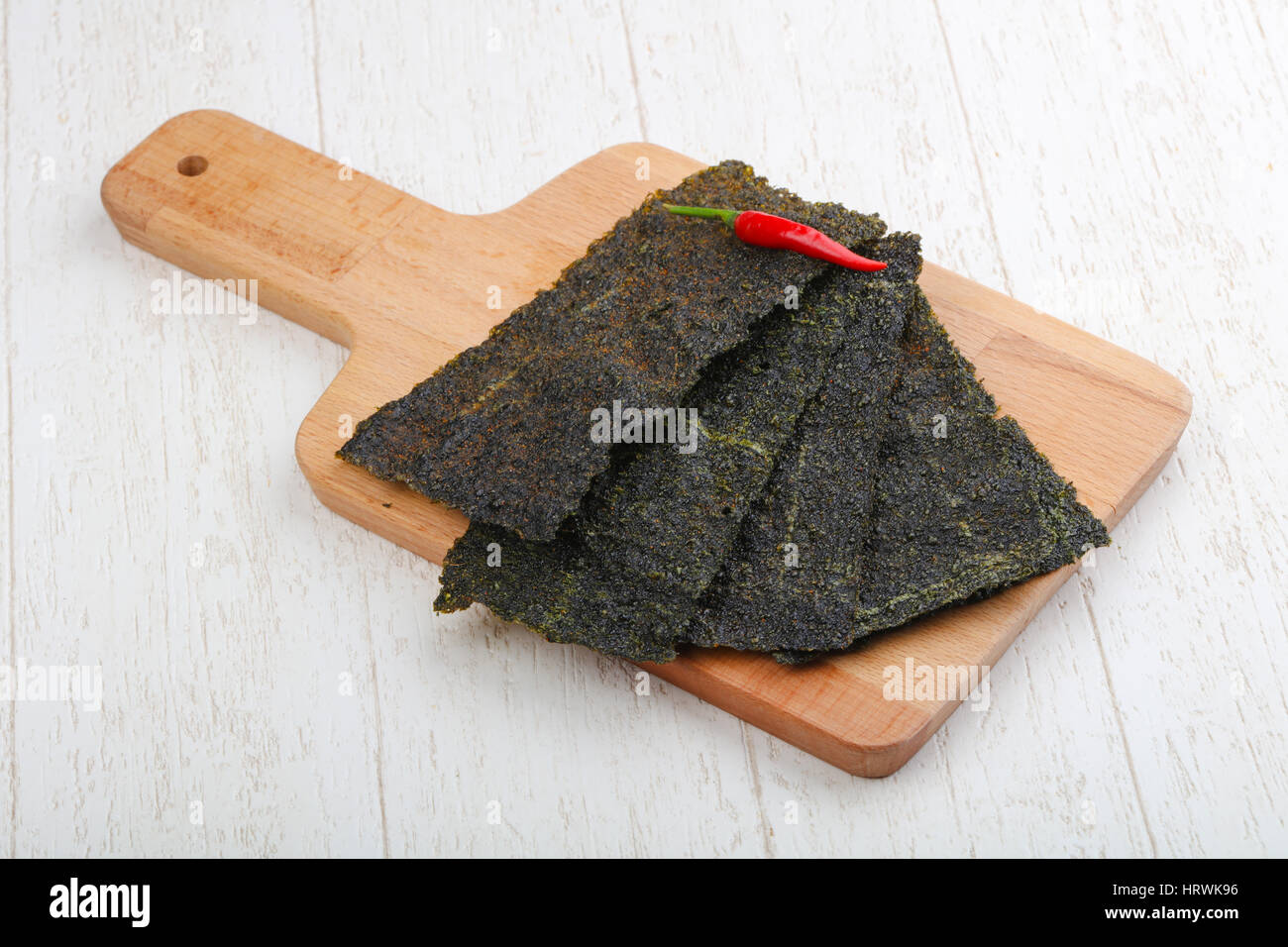 Spicy Nori seaweed sheets with pepper on wood Stock Photo - Alamy