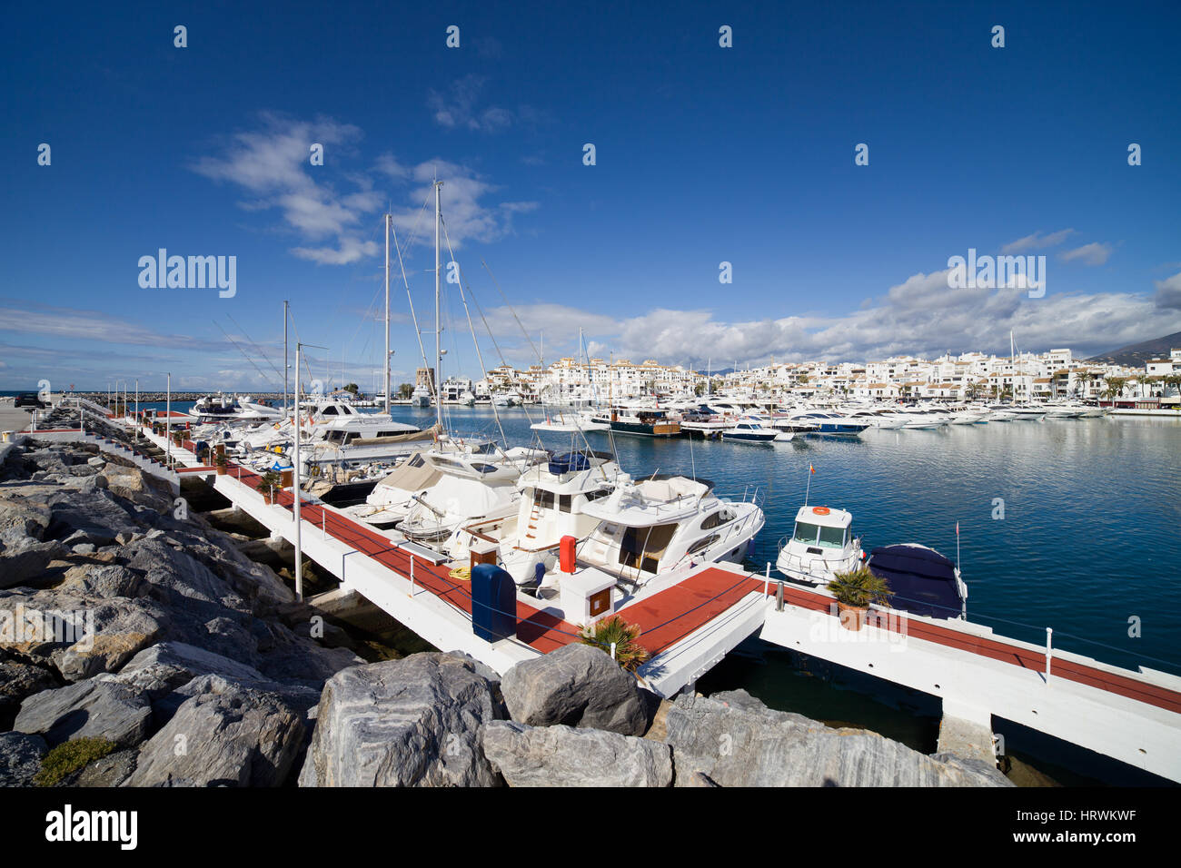 Puerto Jose Banus marina with pier skyline, yachts and sailing boats in ...