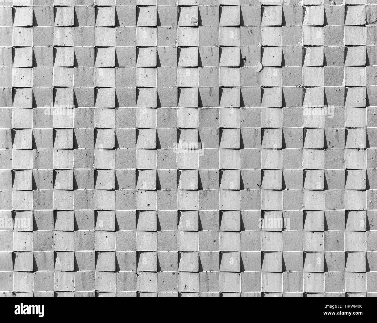 Gray concrete wall with abstract square relief pattern, front view ...