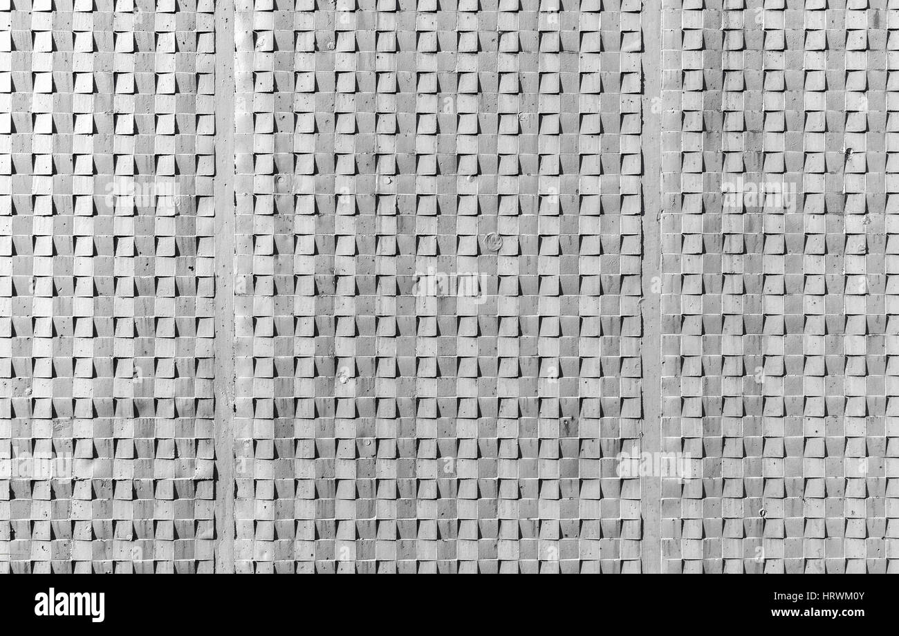 Gray concrete wall with abstract square relief pattern, flat background ...