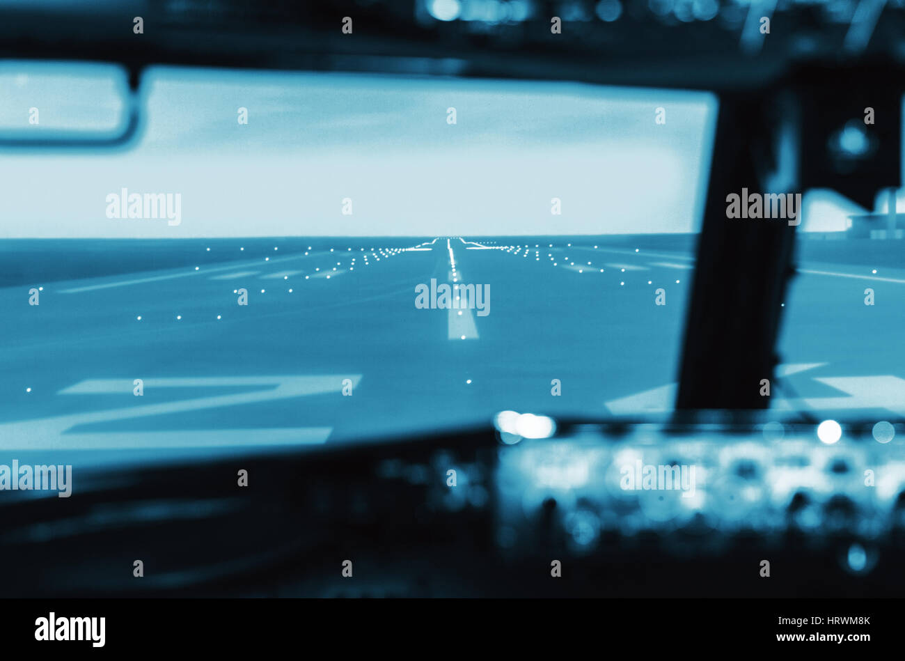 View of the dashboard lit cockpit of a large commercial aircraft ...