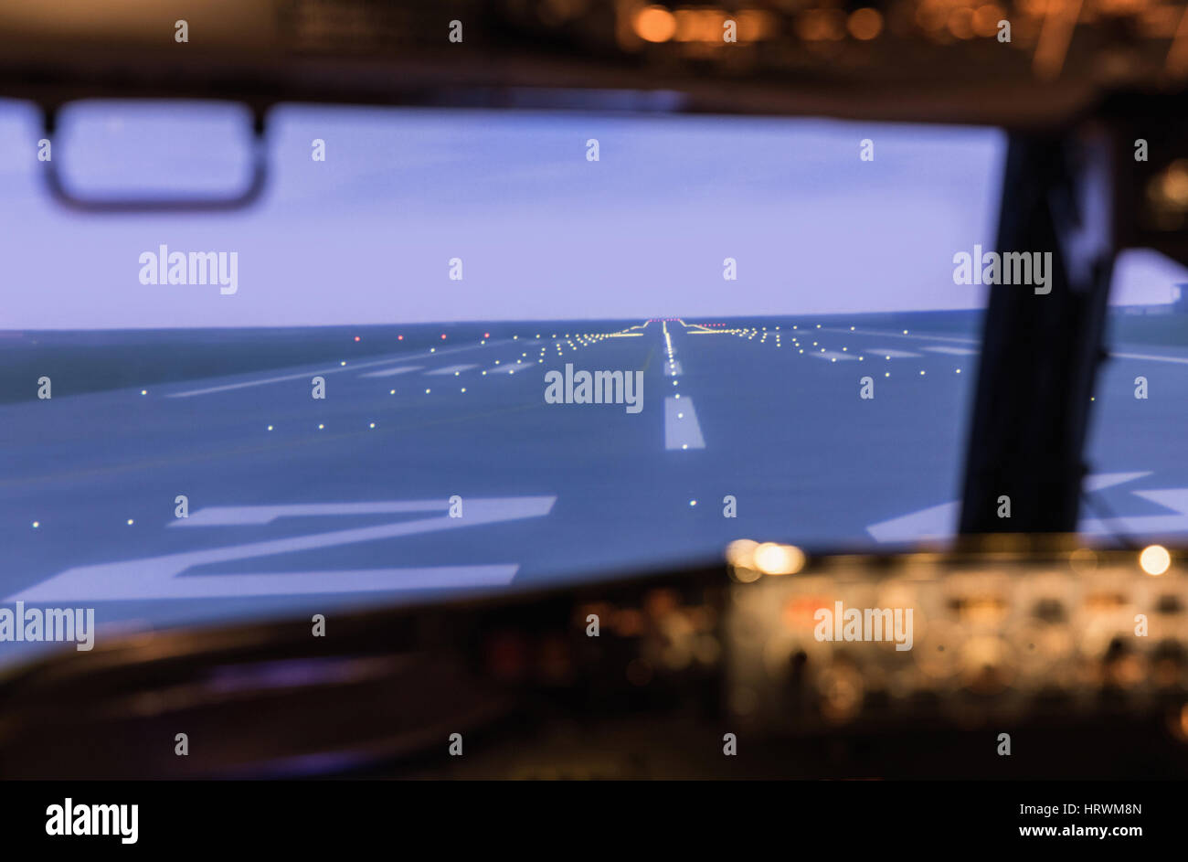 View of the dashboard lit cockpit of a large commercial aircraft ...
