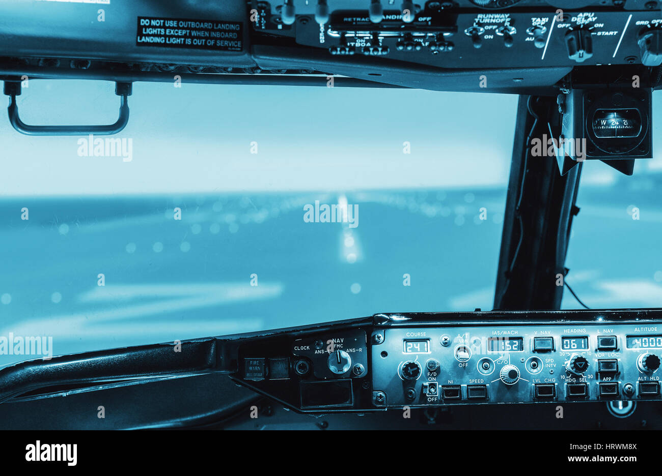 View of the dashboard lit cockpit of a large commercial aircraft ...