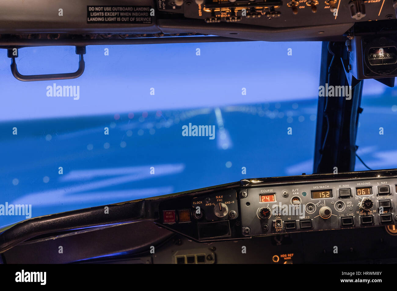 View of the dashboard lit cockpit of a large commercial aircraft ...