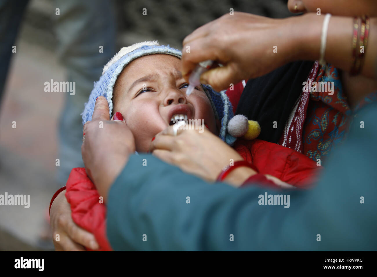 Kathmandu, Nepal. 4th Mar, 2017. A Nepalese child reacts as a volunteer ...