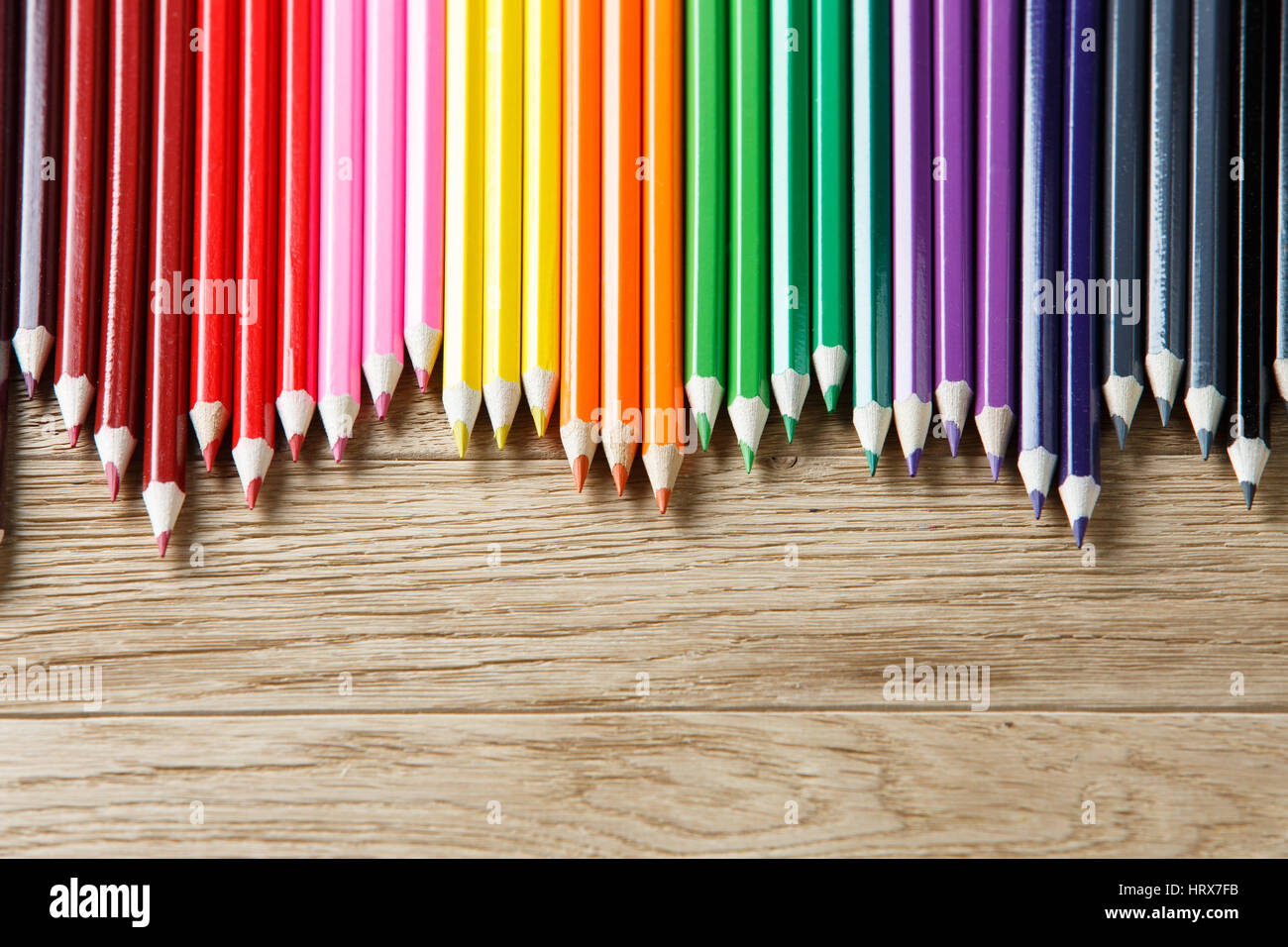 Drawing colorful pencils on a wooden background. Brown table. Pencils ...