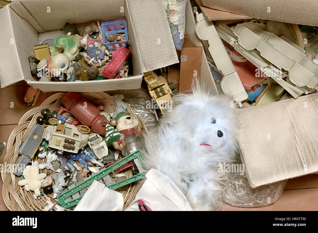 Toys spread out on a floor, mess in a playroom. Overhead filtered shot ...
