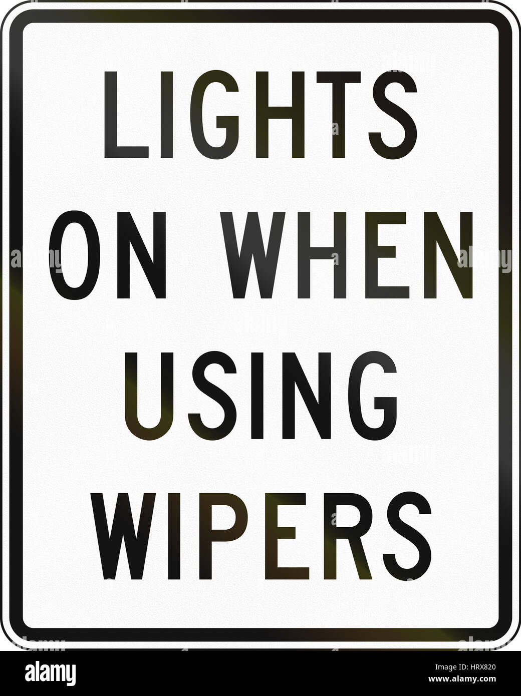 United States MUTCD road sign - Lights on when using wipers Stock Photo ...
