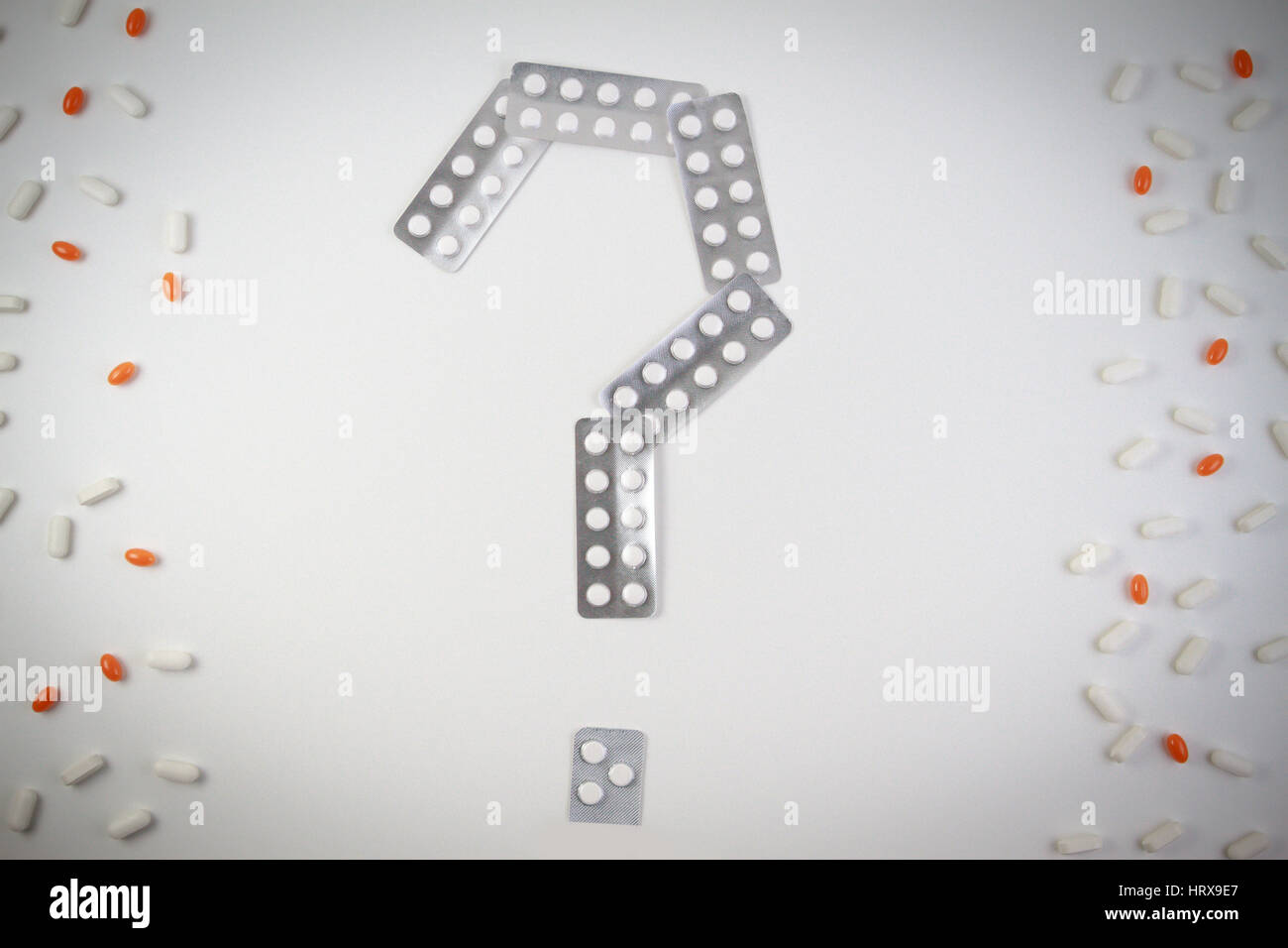 Pills in blister pack in the shape of a question mark and tablets on ...