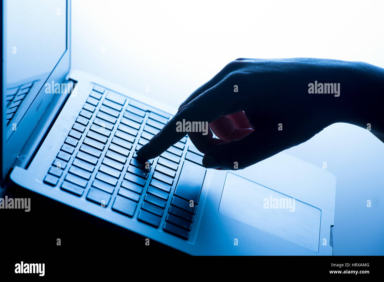 A woman's hand presses a key of a laptop keyboard Stock Photo - Alamy