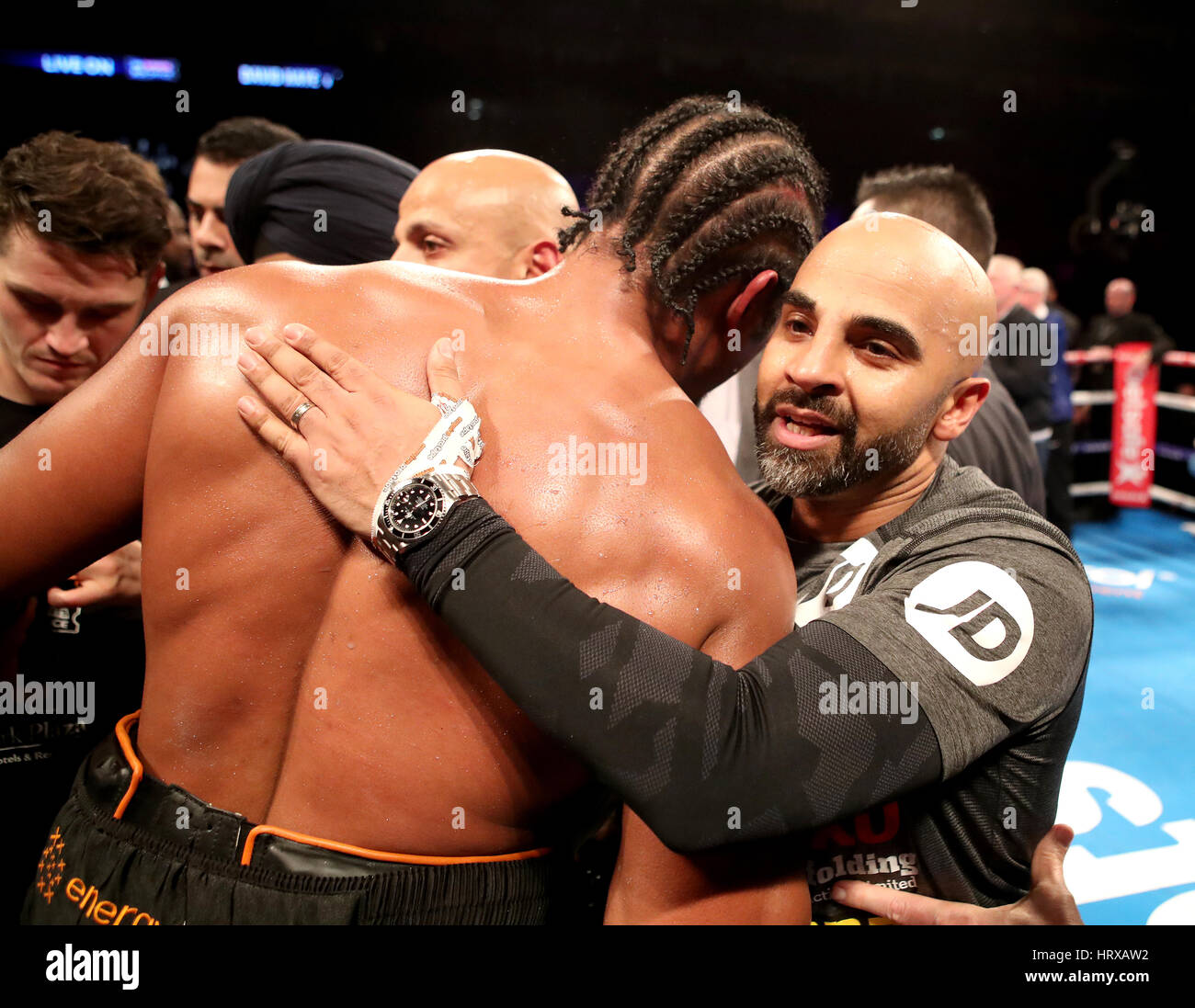 David Haye is embraced by the trainer of Tony Bellew, Dave Coldwell ...