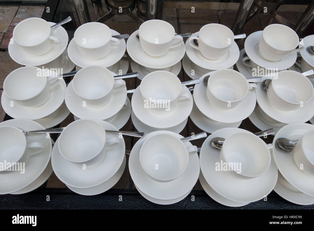 A row of empty tea cups and saucers on a buffet counter Stock Photo - Alamy