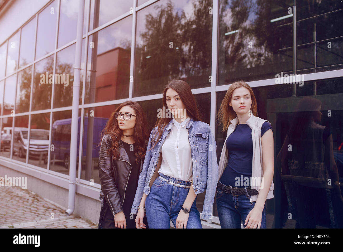 stylish young model walk in the street and pose for a photo on a Sunny ...