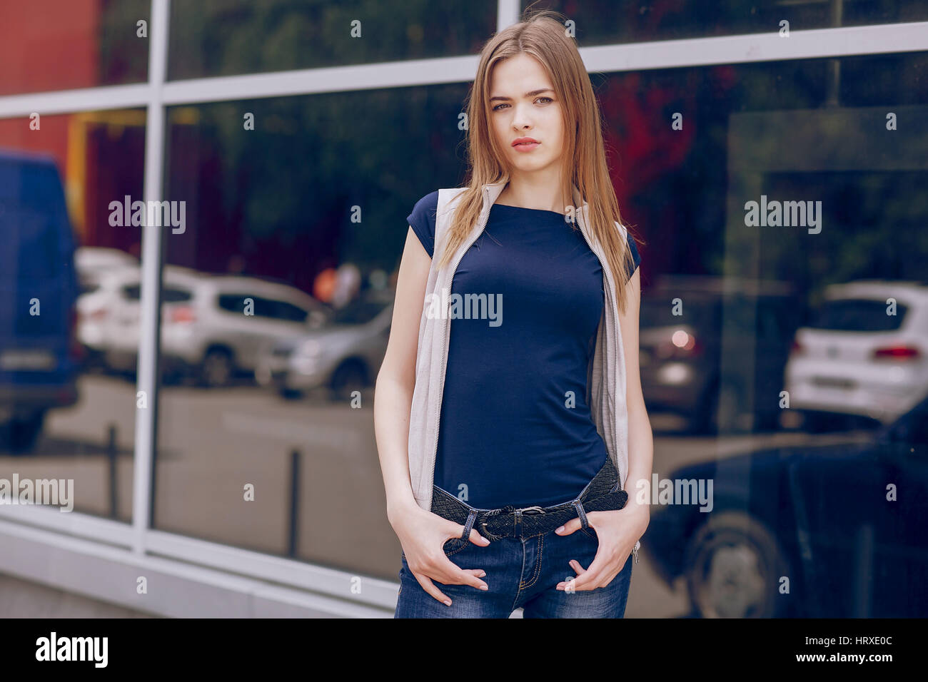 stylish young model walk in the street and pose for a photo on a Sunny ...