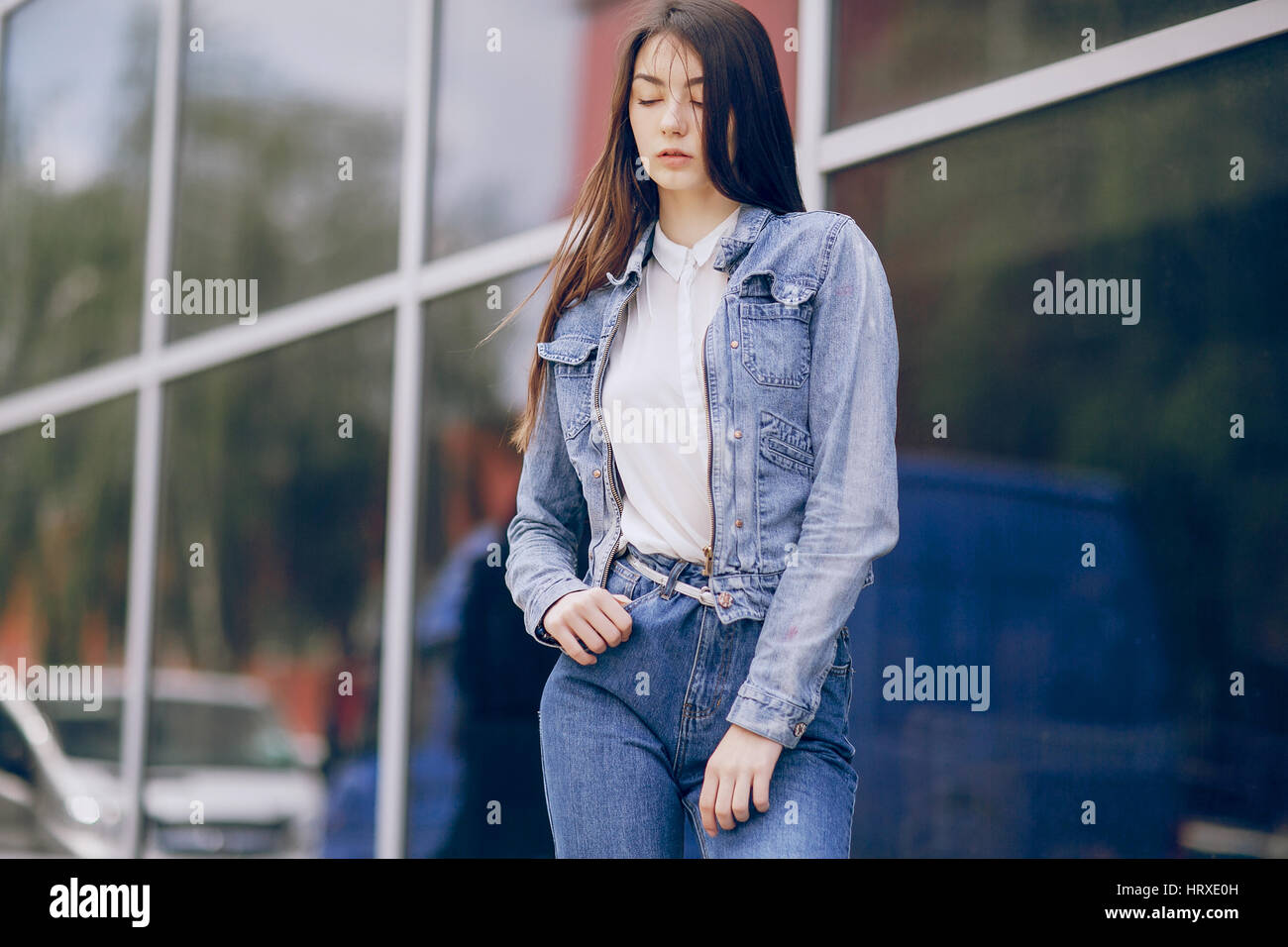 stylish young model walk in the street and pose for a photo on a Sunny ...